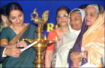 rediff.com: Alka Ahuja lights a lamp to mark the Women's Day celebrations